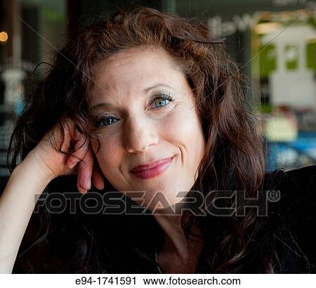 Stock Photography of Portrait of a 42 year old woman with long curly ...