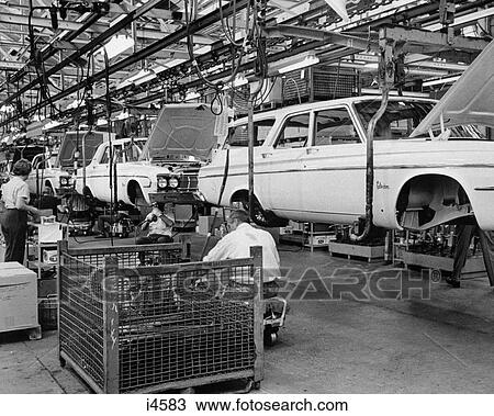 1960S Chrysler Assembly Line With Car Bodies Elevated For Employees To ...