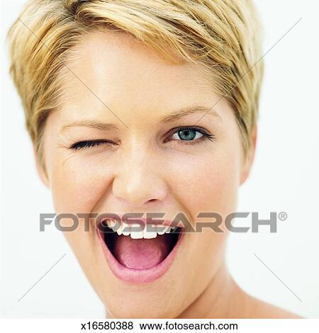 Pictures of Front view portrait of young woman smiling and winking her ...