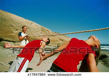 Stock Photo of a group of young teenagers doing the limbo (14-16 ...