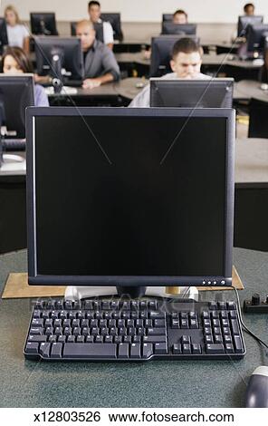 Stock Images of College students using computers (focus on computer in ...