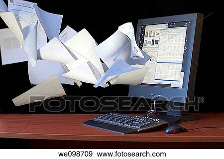 Stock Photograph of Papers flying into a flat screen computer monitor ...