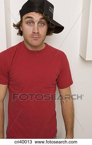Man wearing tilted baseball cap Stock Image | cri40013 | Fotosearch